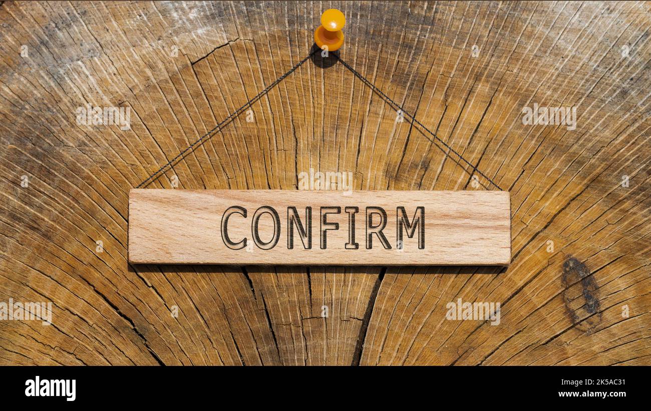Confirm. Written on wooden hanging frame. Background wood cut log Stock ...