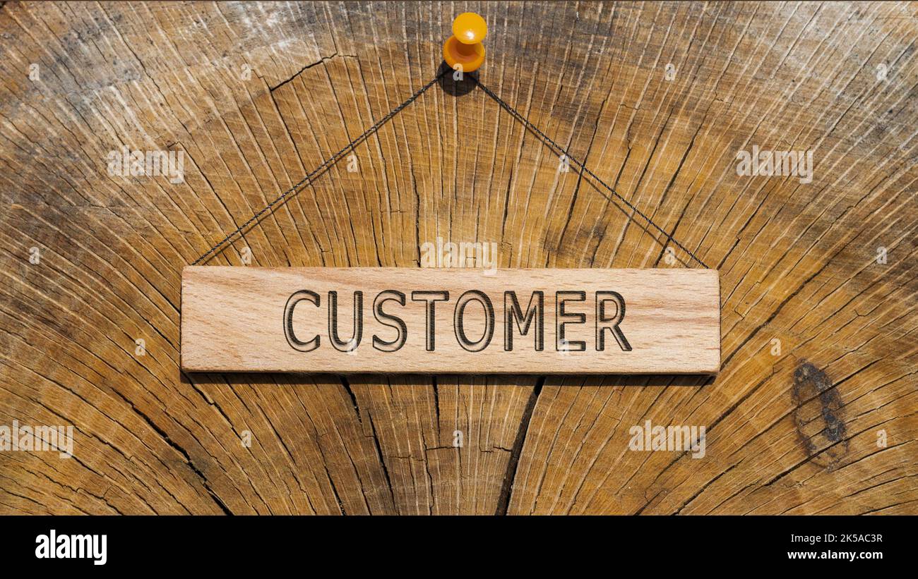 customer text . Written on wooden hanging frame. Background wood cut ...