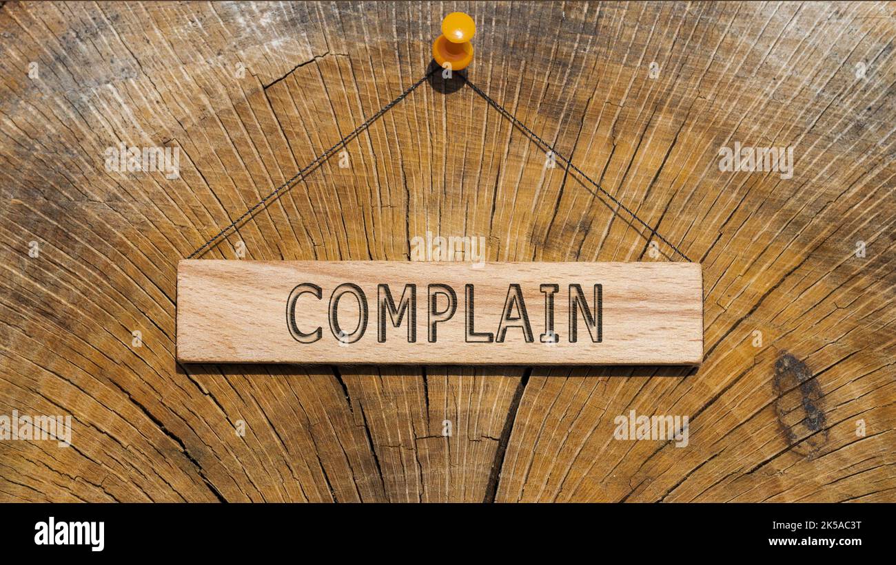 Complete text. Written on wooden hanging frame. Background wood cut log ...