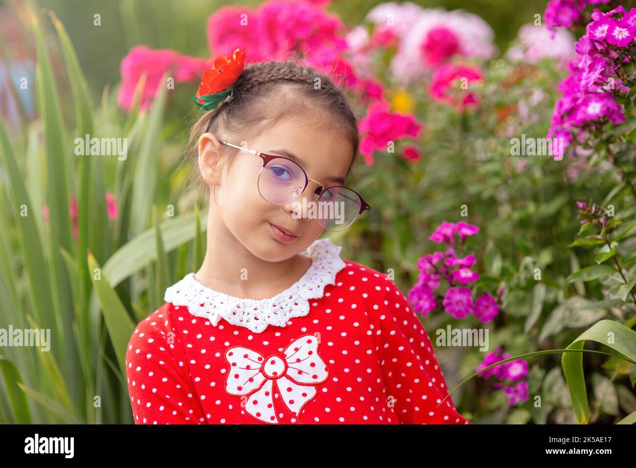 A portrait of beautiful little girl in glasses in garden Stock Photo ...