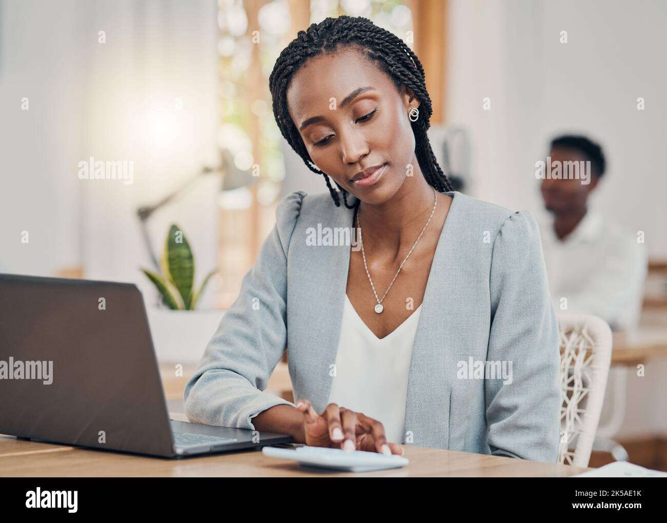 Accounting, business and black woman typing on calculator while working ...