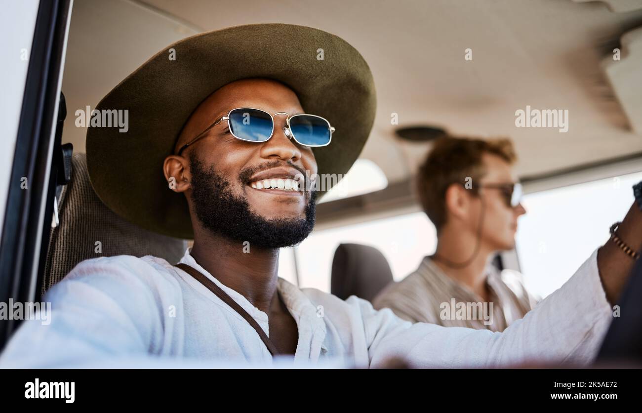Happy, smile and black man driving a car while on a summer road trip ...