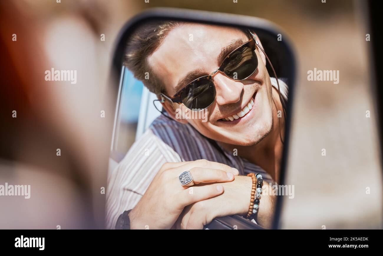 Car mirror reflection, road trip and face of man happy, smile or relax ...