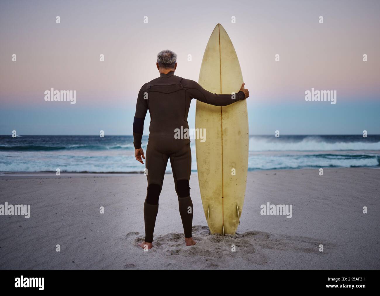 Man standing on beach surfboard hi-res stock photography and images - Alamy