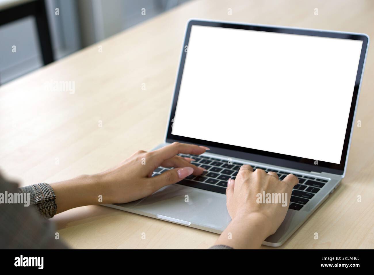 Back view of businesswoman in a plaid pattern suit sit at desk in ...