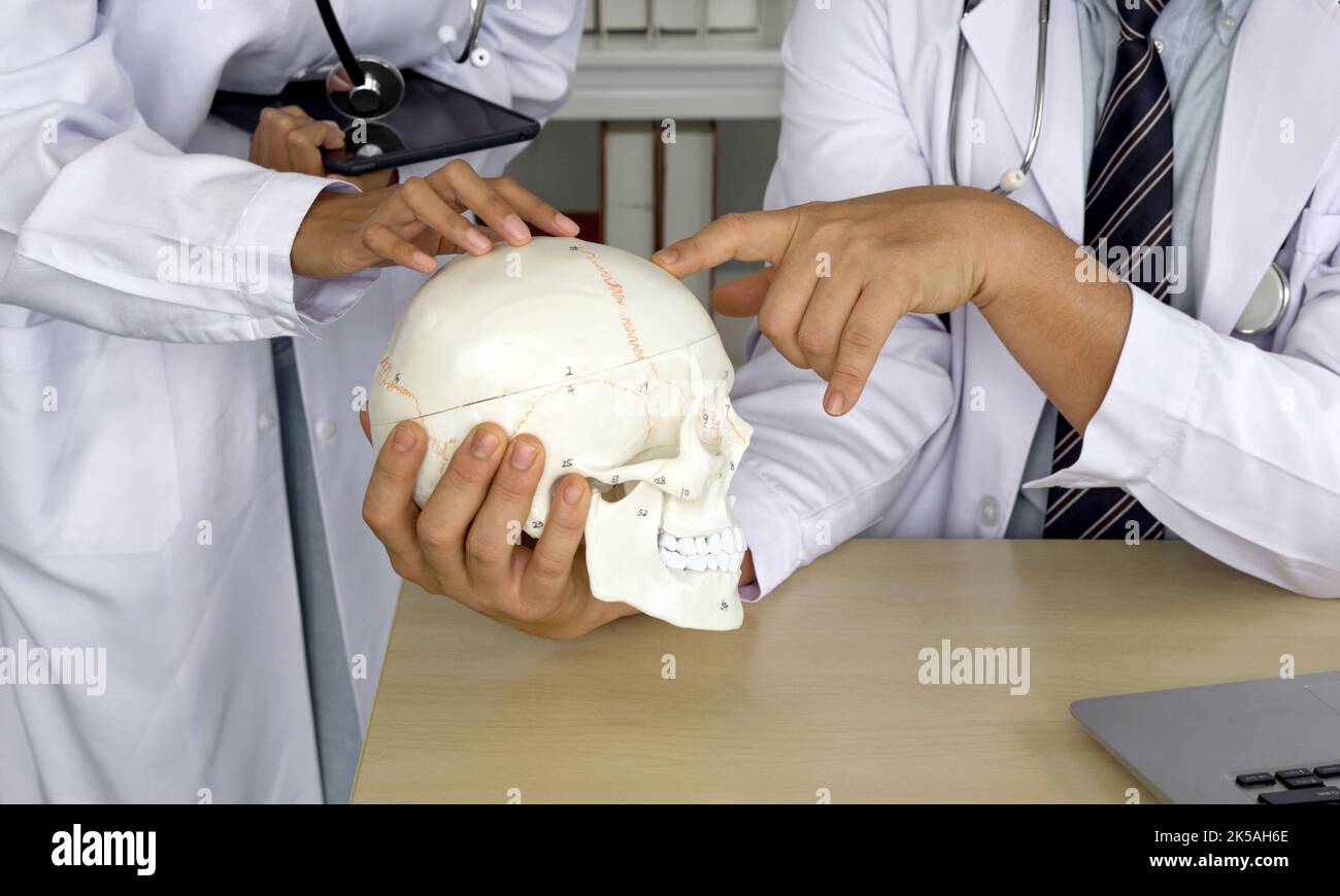 Young asian doctor in white gown and stethoscope asking for the ...
