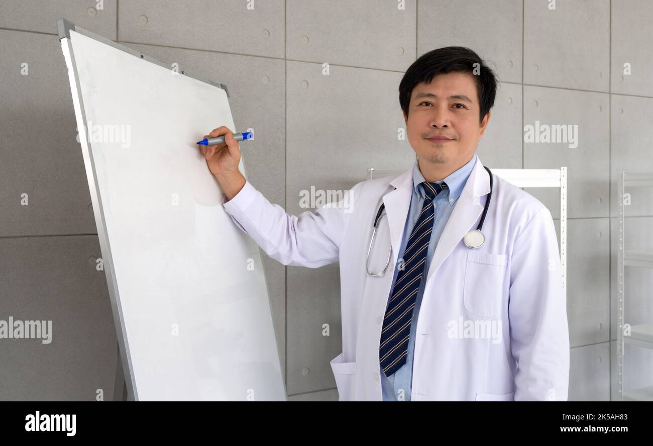 Asian doctor in white gown and stethoscope holding blue magic pen ...