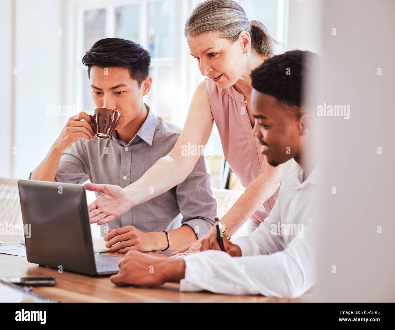 Training, laptop and startup team with leader working in modern office. Teamwork, collaboration ...