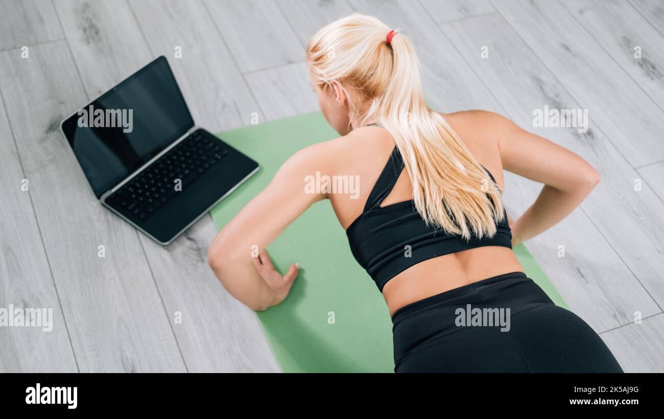 strong body female trainer online training home Stock Photo - Alamy