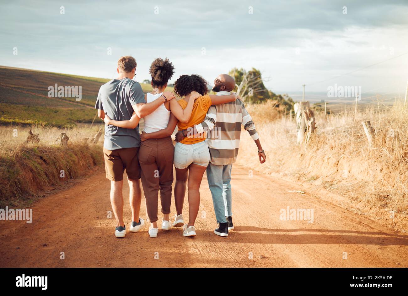 Hug, friends and walking with back view in countryside for group ...