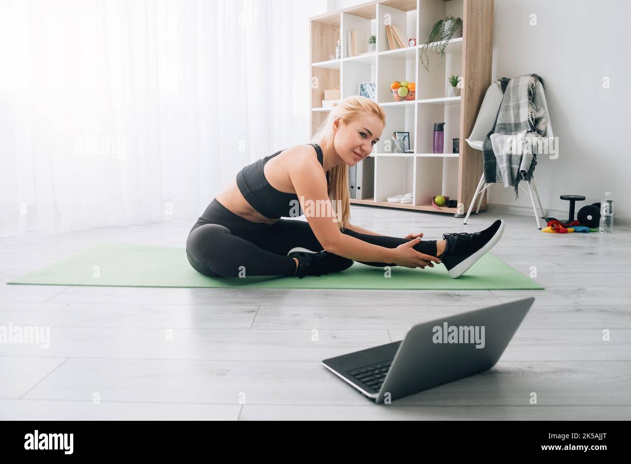home stretching female sport online fitness Stock Photo - Alamy