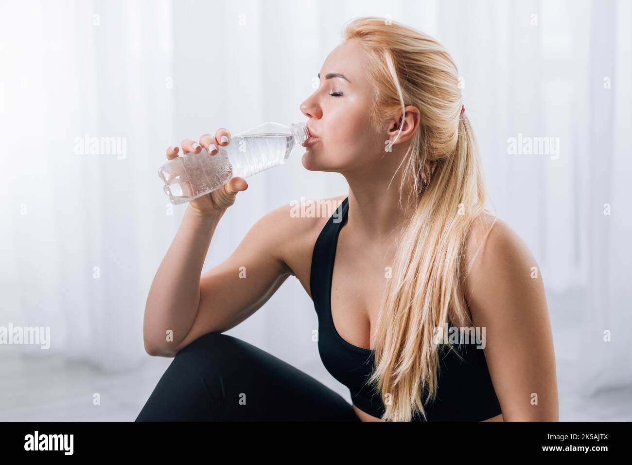 Woman drinking water home hi-res stock photography and images - Alamy