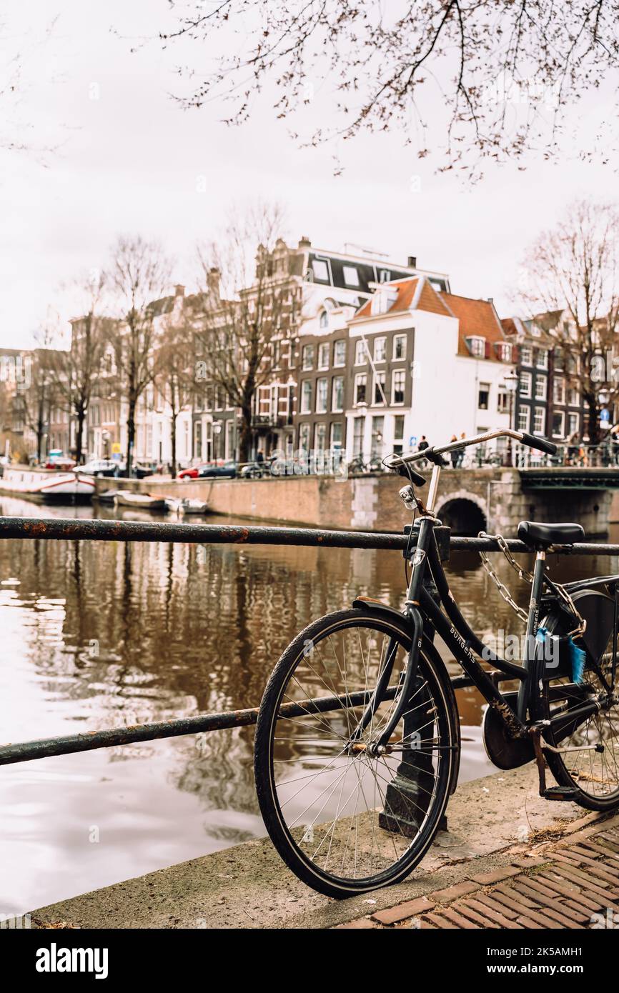 View of Amsterdam through bicycle wheels Storehouses Netherlands Holland Stock Photo - Alamy