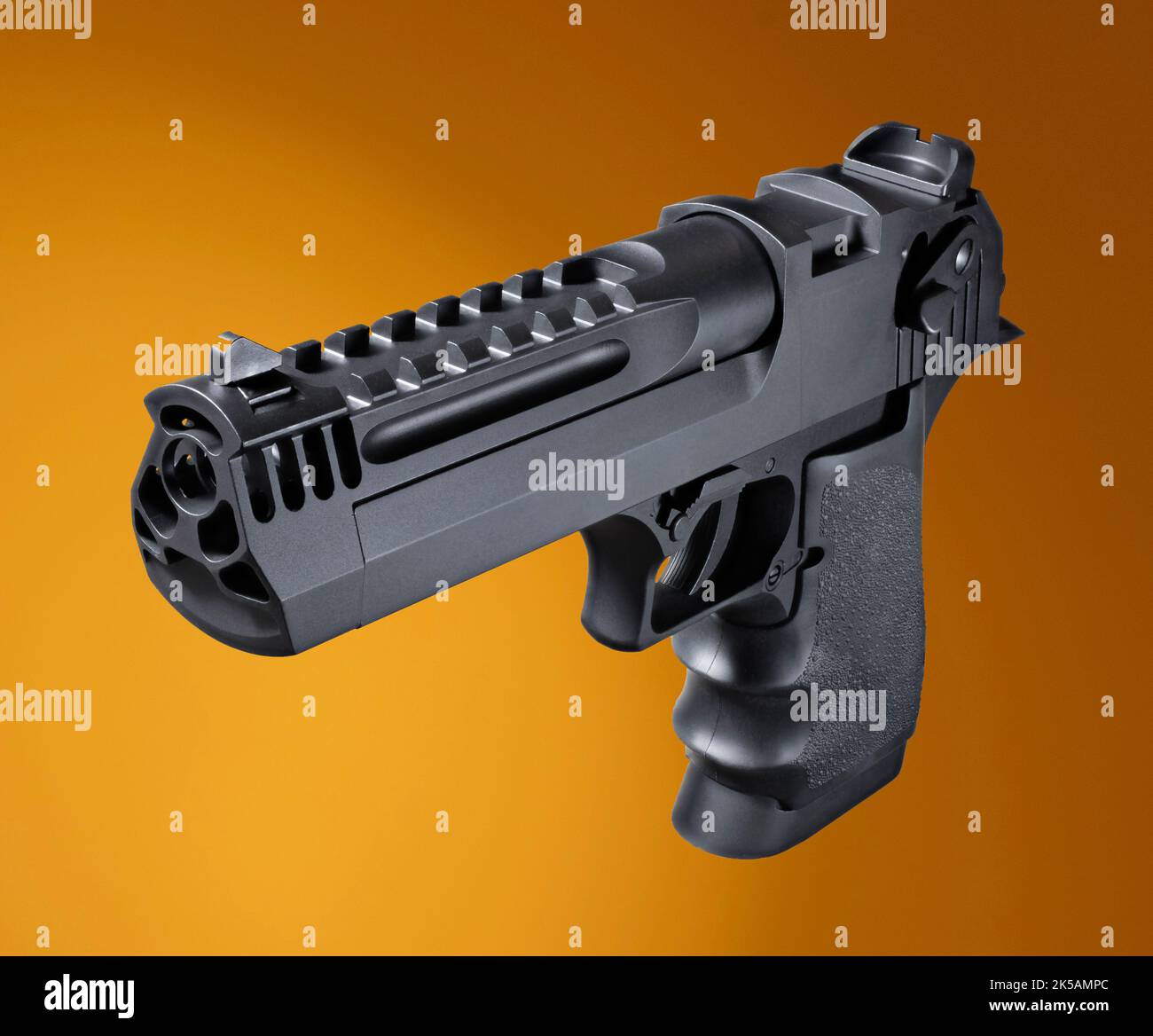 Handgun angled slightly toward the viewer on an orange background Stock ...