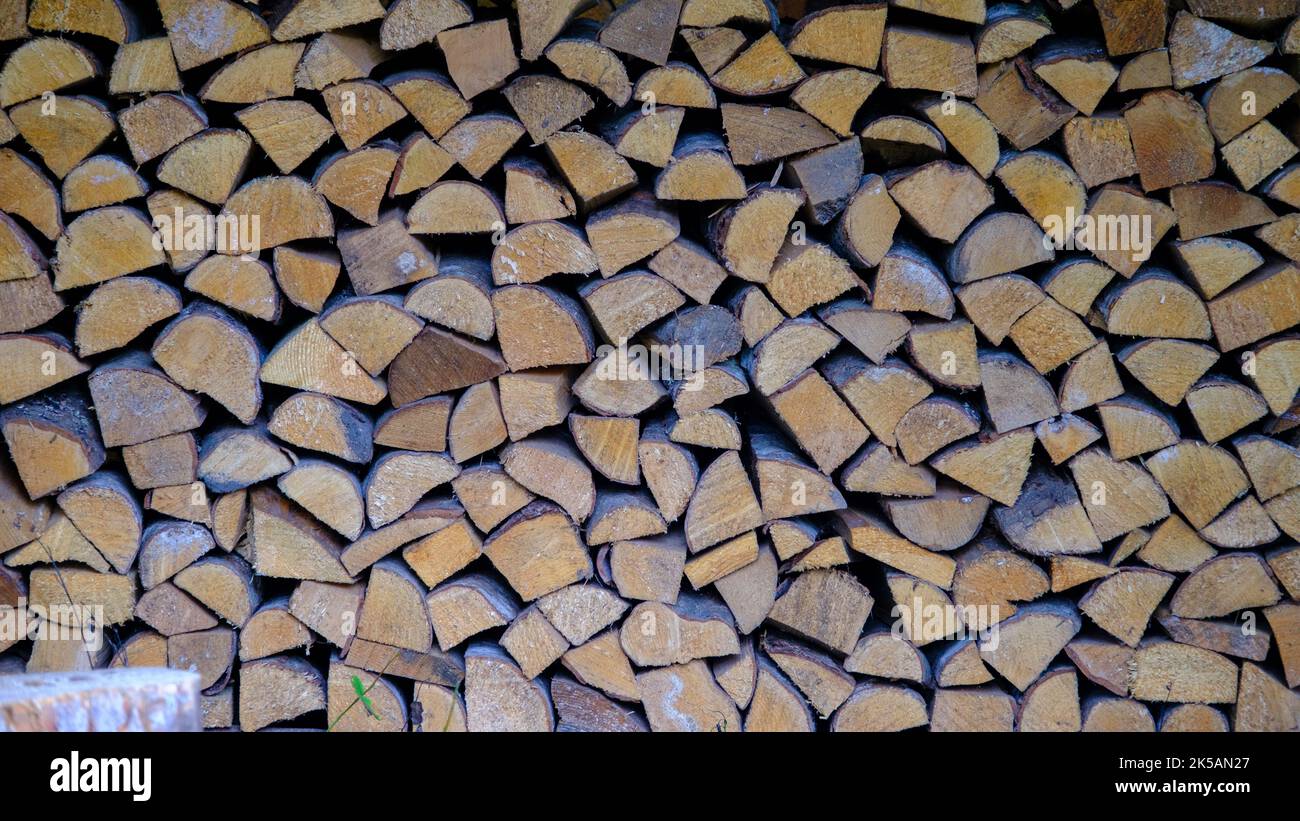 A wall of firewood, a background of dry chopped firewood stacked in ...