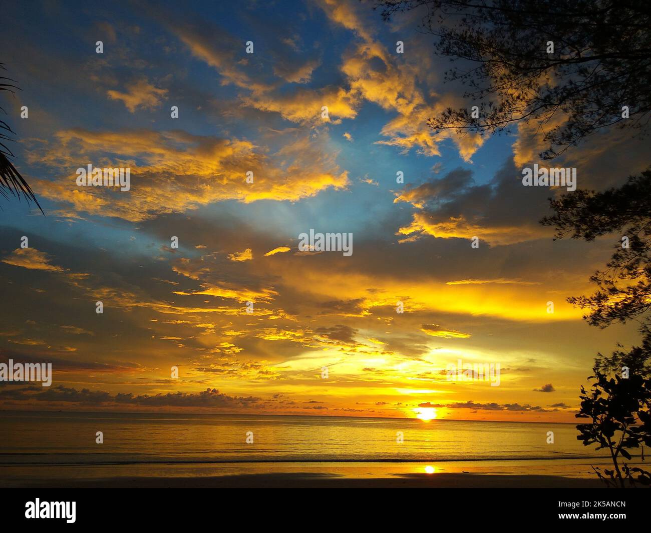 A dramatic scenery of a beautiful and vibrant sunset in the cloudy sky ...