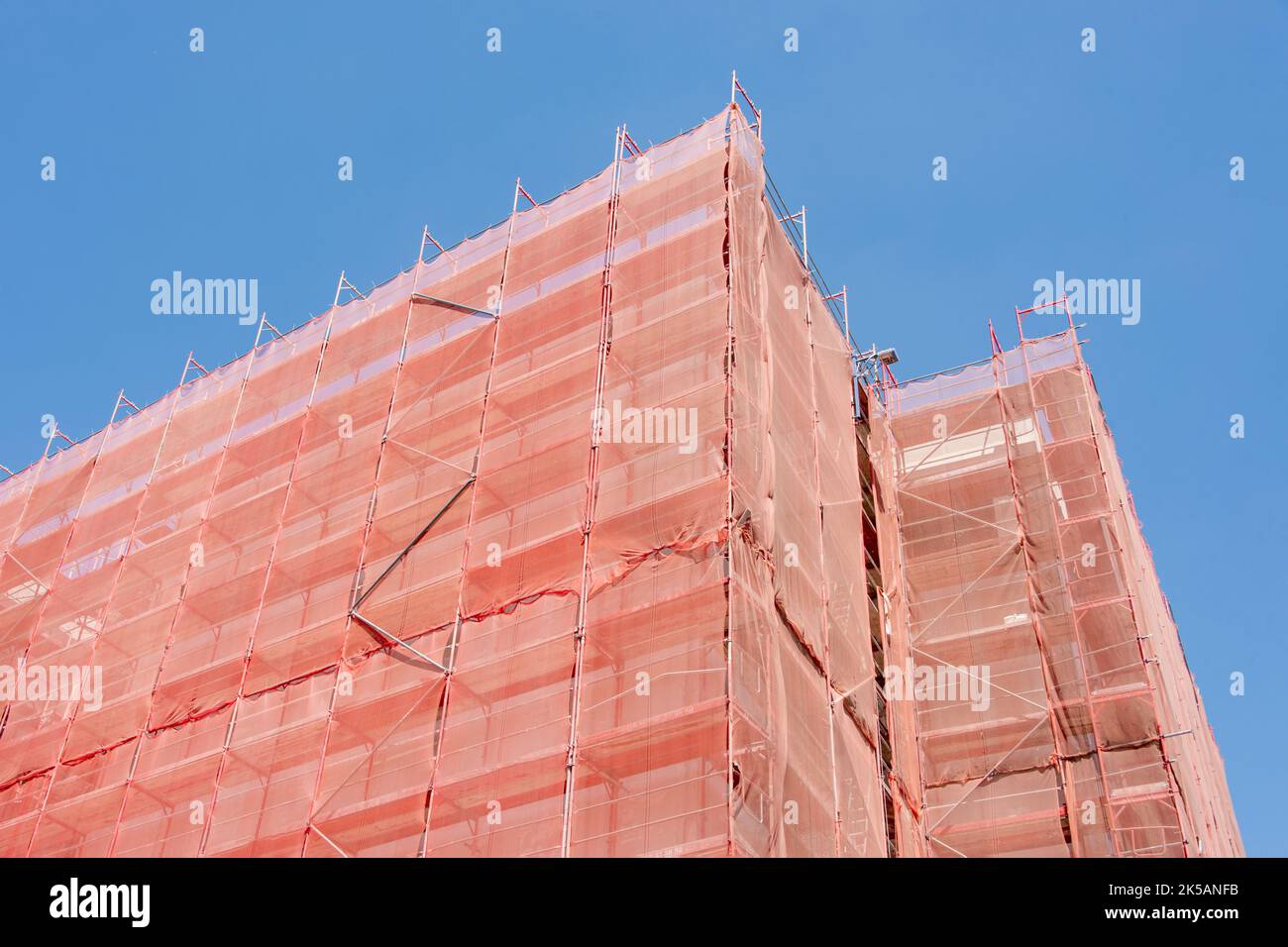 Building facade corner under construction is covered with a protective ...
