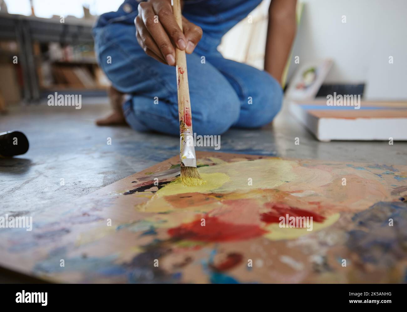 Artist woman, painting and paint brush on art studio floor being ...