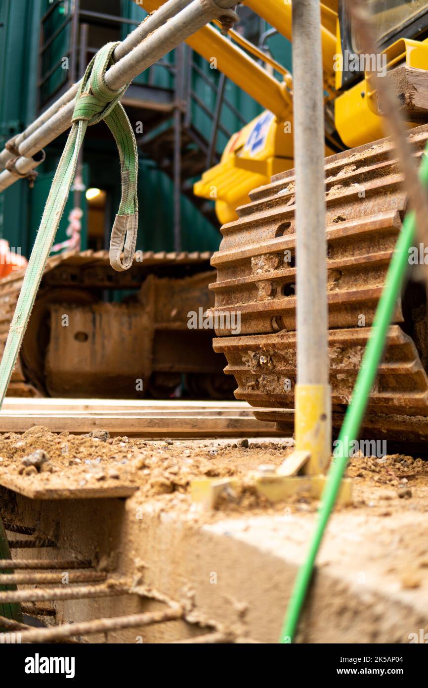 Detail of excavator tracks on construction site on a reinforced ...