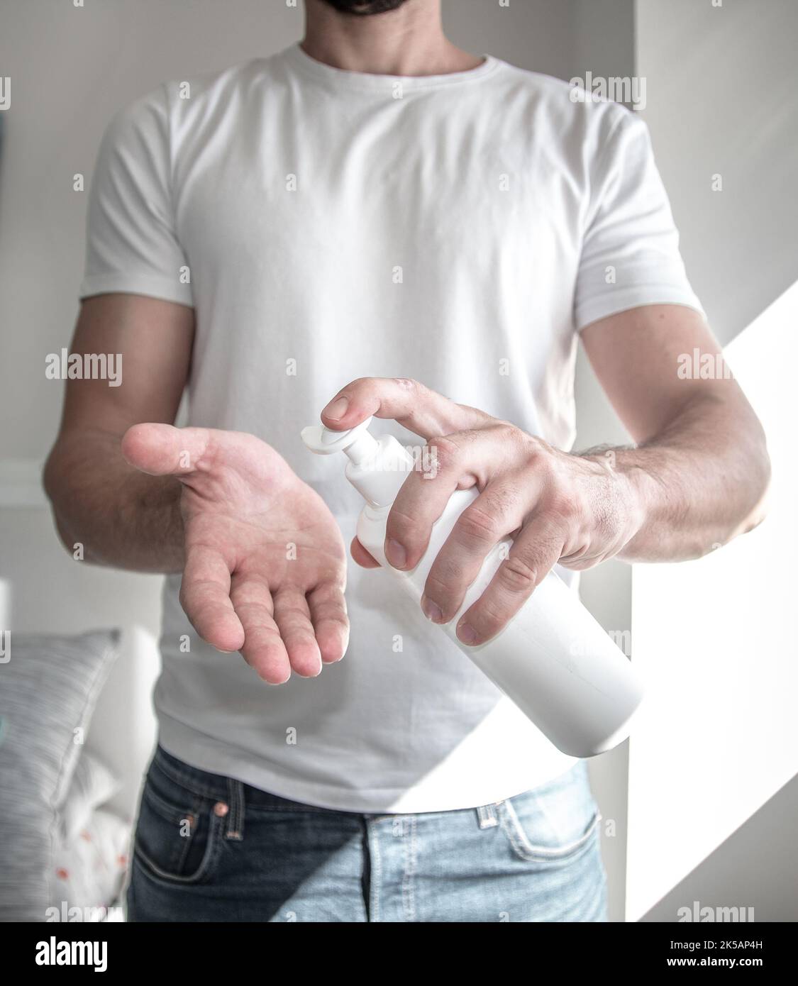 A Caucasian male with psoriasis - a skin condition, holding medicine in ...