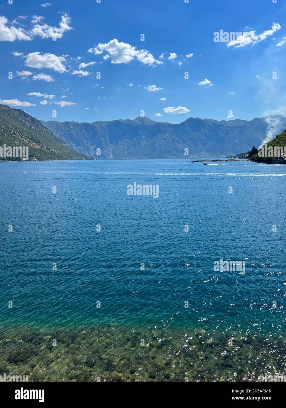 A gorgeous vertical shot of the Verige Strait in Montenegro with bright ...