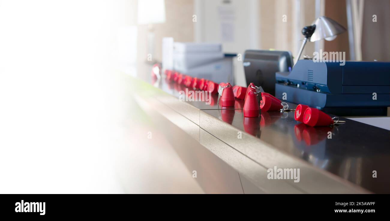 The hotel receptionist with red keys on sun light. Selective focus ...
