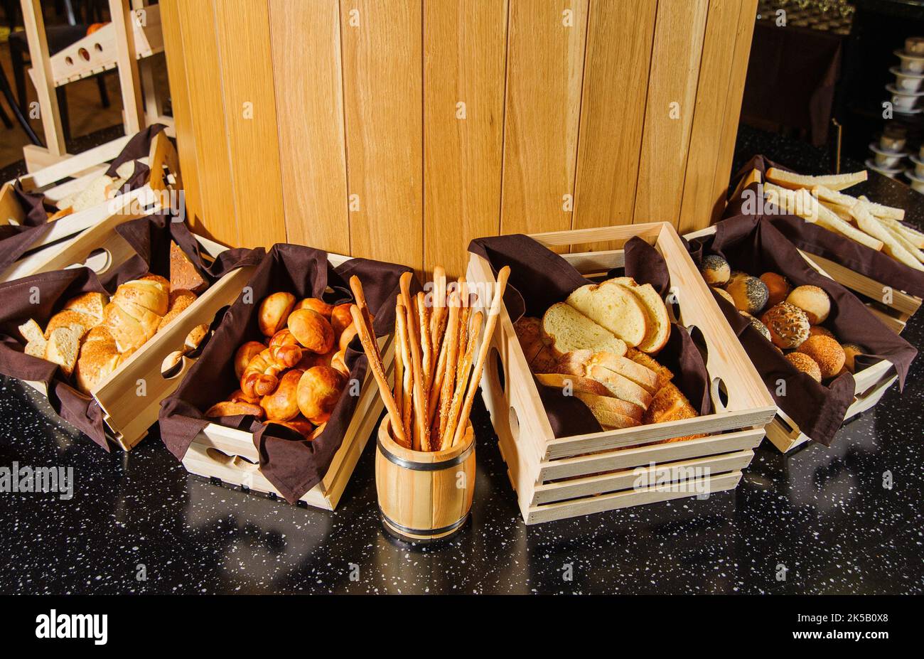 A buffet table with variety of bread in the wooden baskets Stock Photo ...