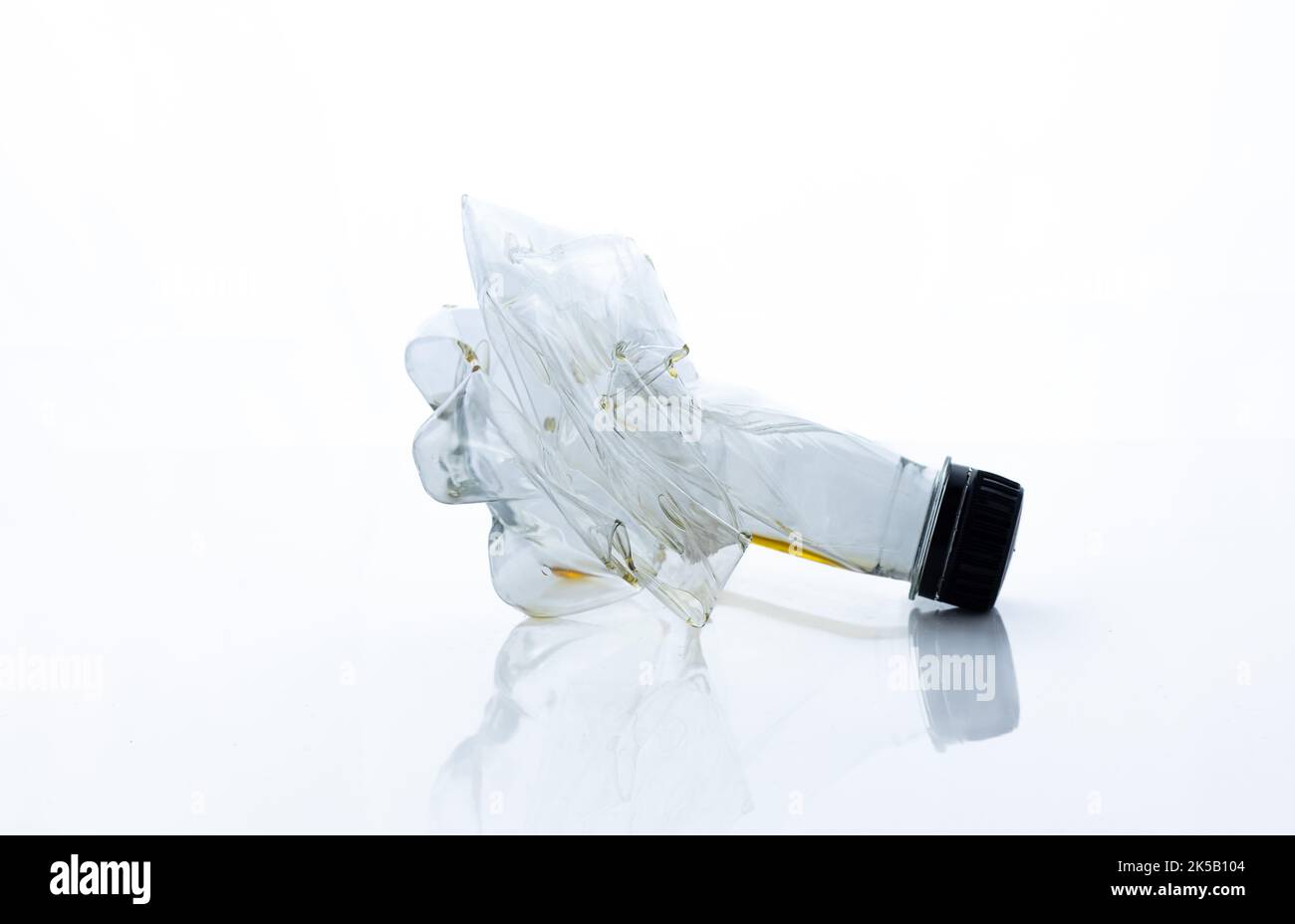 A squashed plastic bottle isolated in the white background Stock Photo ...