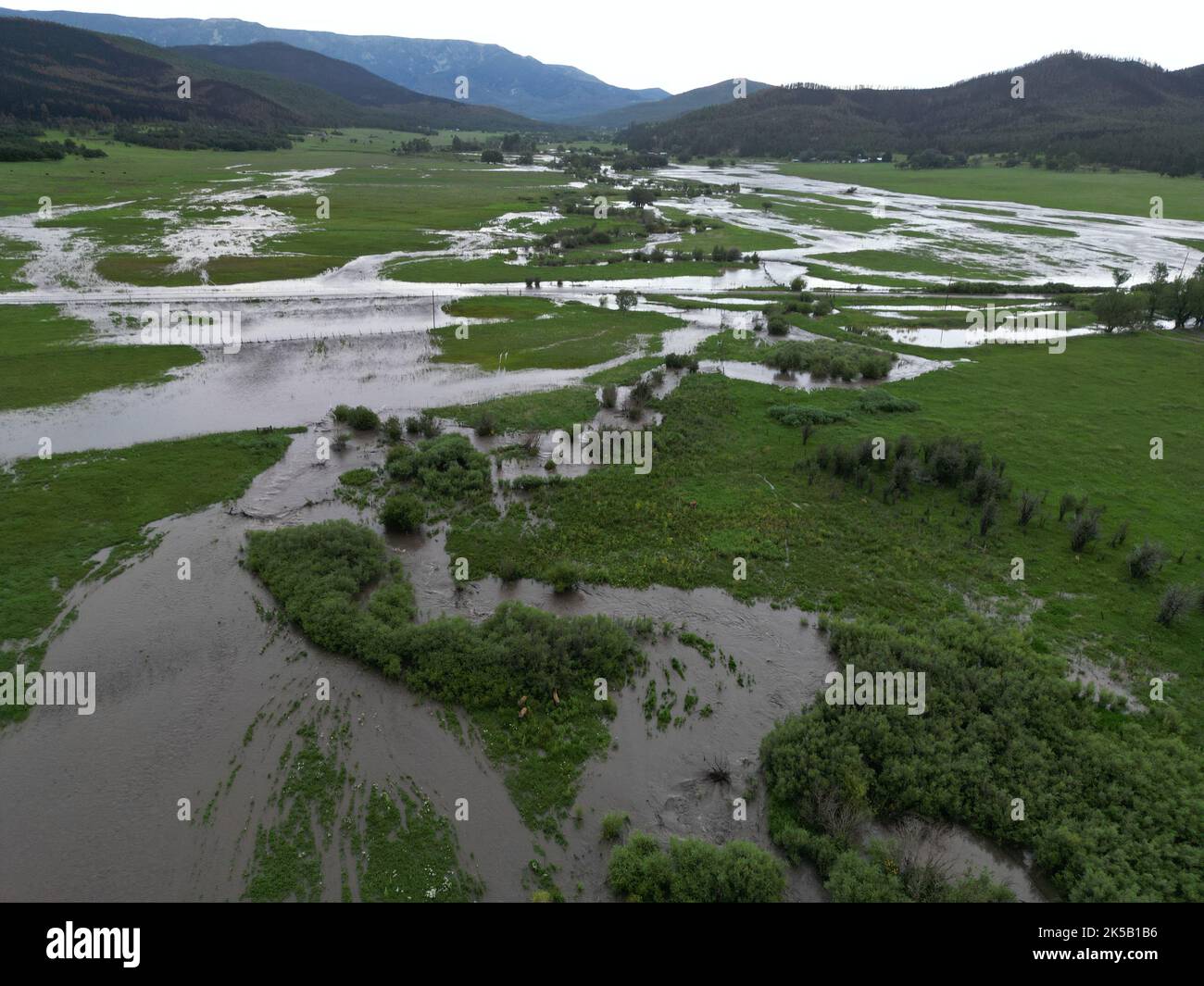 An aerial shot of extreme flooding and natural disasters in open green ...