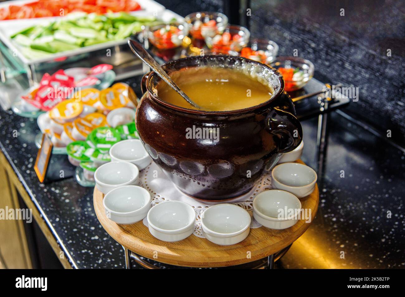 A bowl of soup puree on a buffet table with small bowls around Stock ...