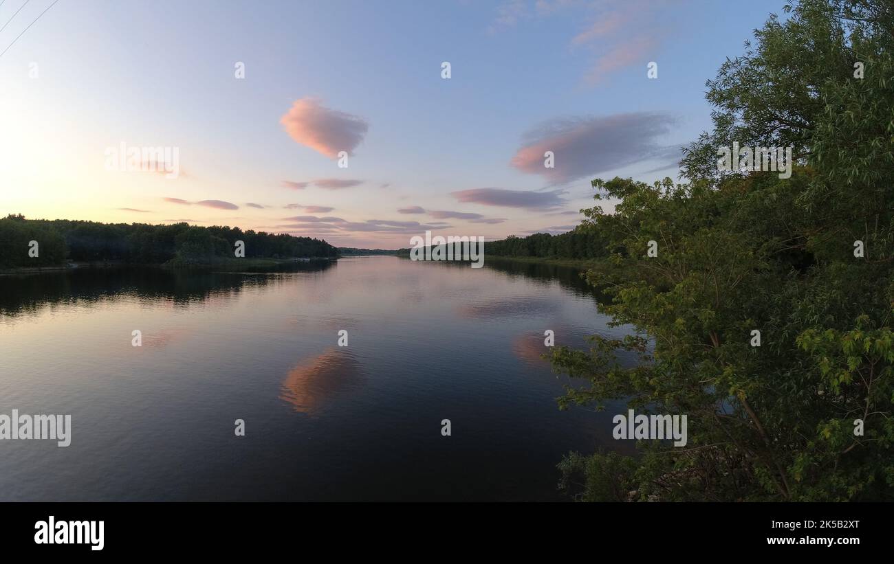 A mesmerizing soft sunset reflecting on the lake water Stock Photo - Alamy