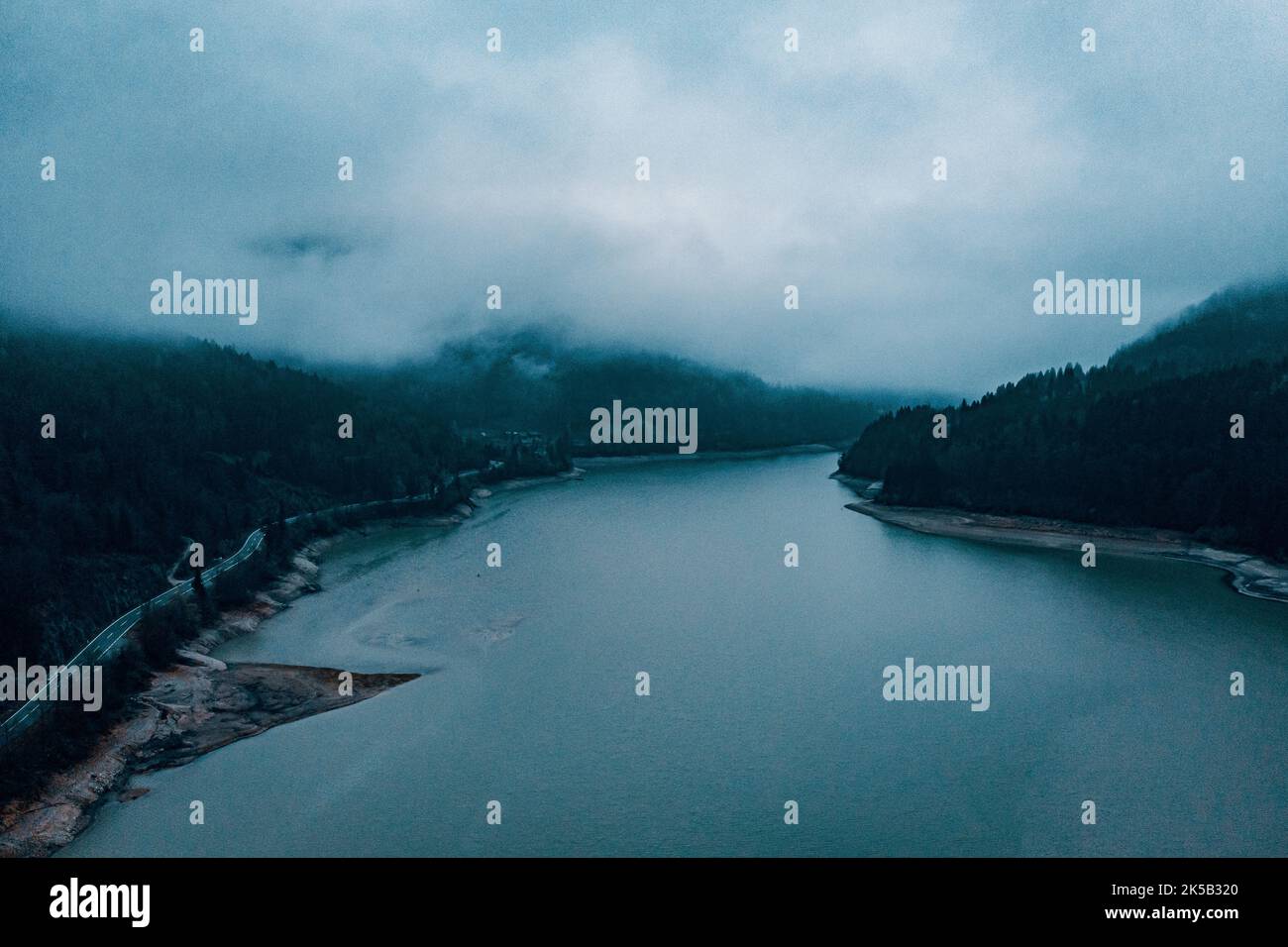 An aerial view of water area in Wiestalstausee reservoir covered in fog ...