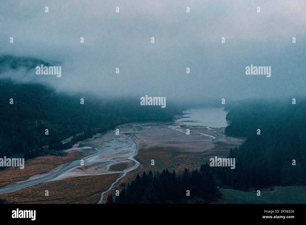 An aerial view of water area in Wiestalstausee reservoir covered in fog ...