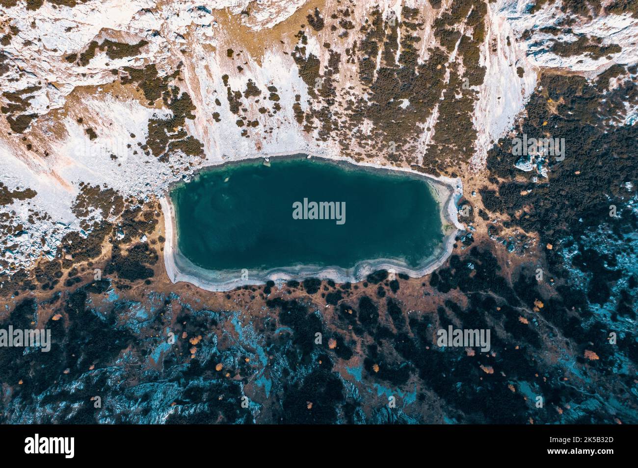 An aerial view of Seetalsee lake surrounded by snowcap ridge mountains ...