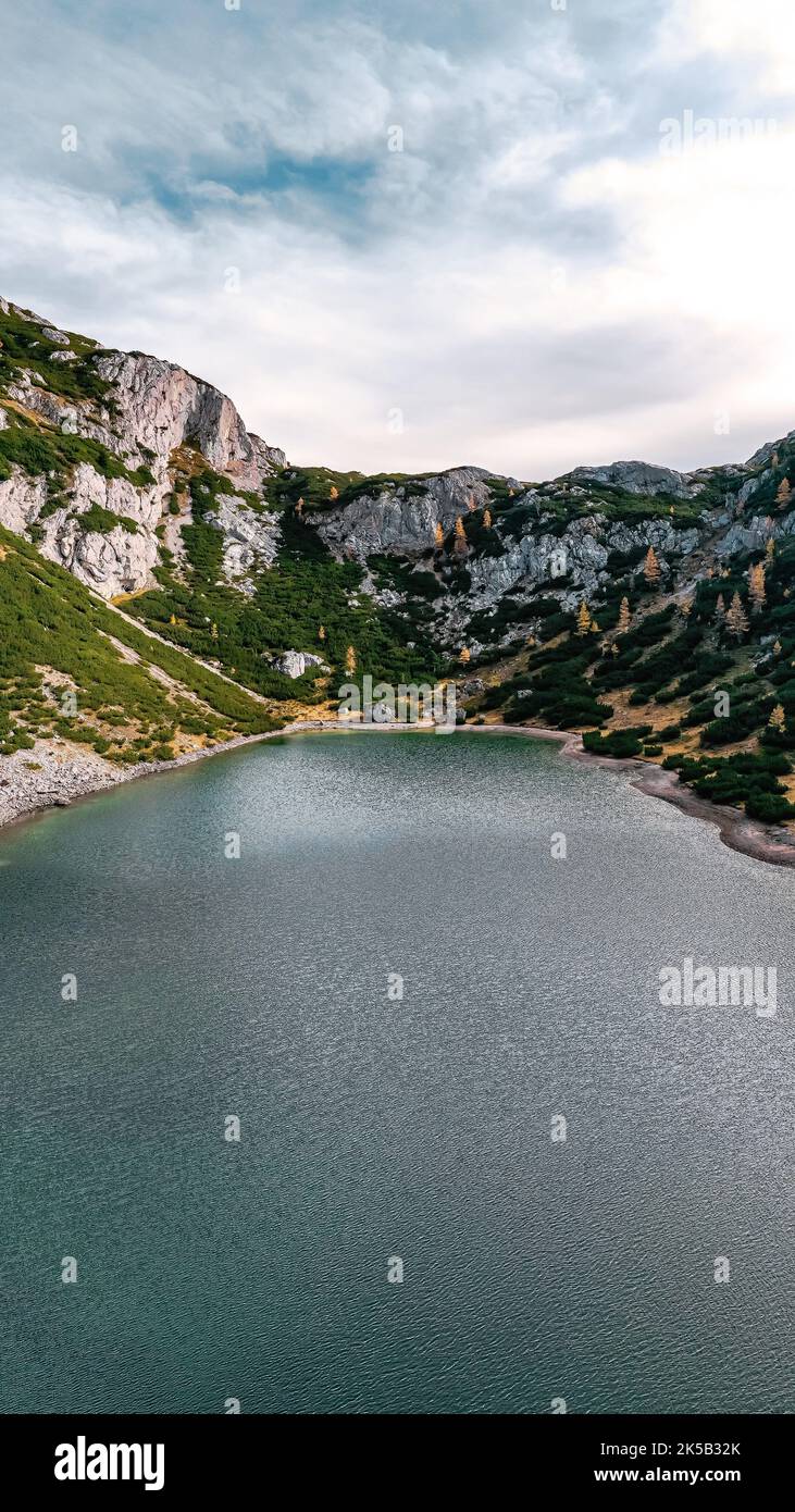 An aerial view of Seetalsee lake surrounded by steep ridge mountains in ...