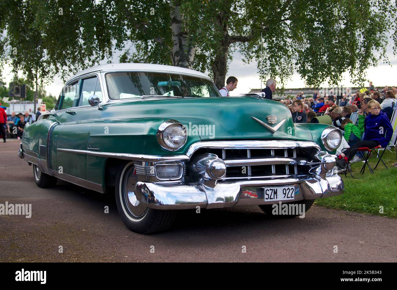 A vintage Cadillac Series 62 green car with a white top and round ...