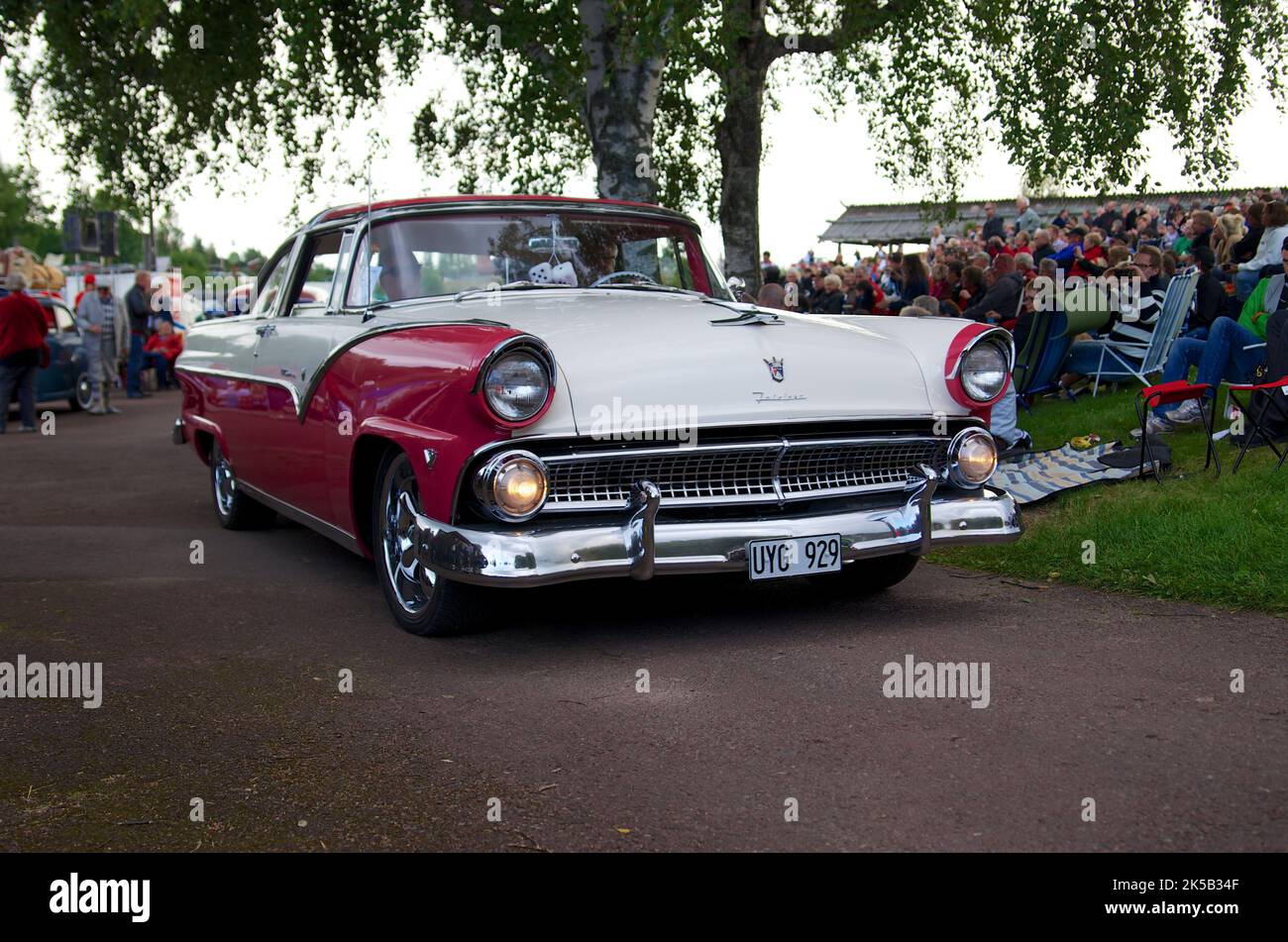 A vintage Ford Fairlane Crown Victoria pink car with round headlights ...