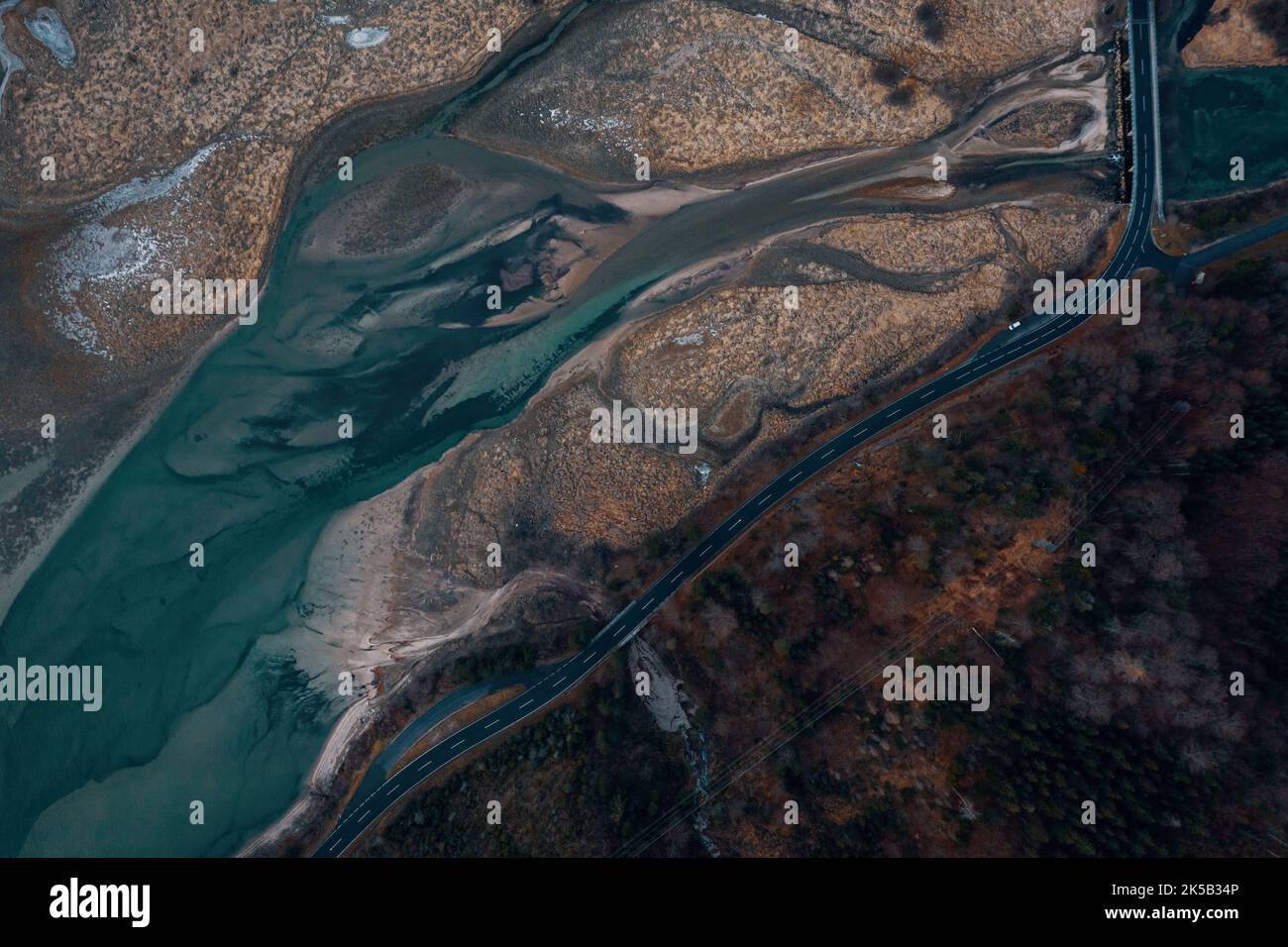 A breathtaking nature view of a blue crystal river under mountains from ...