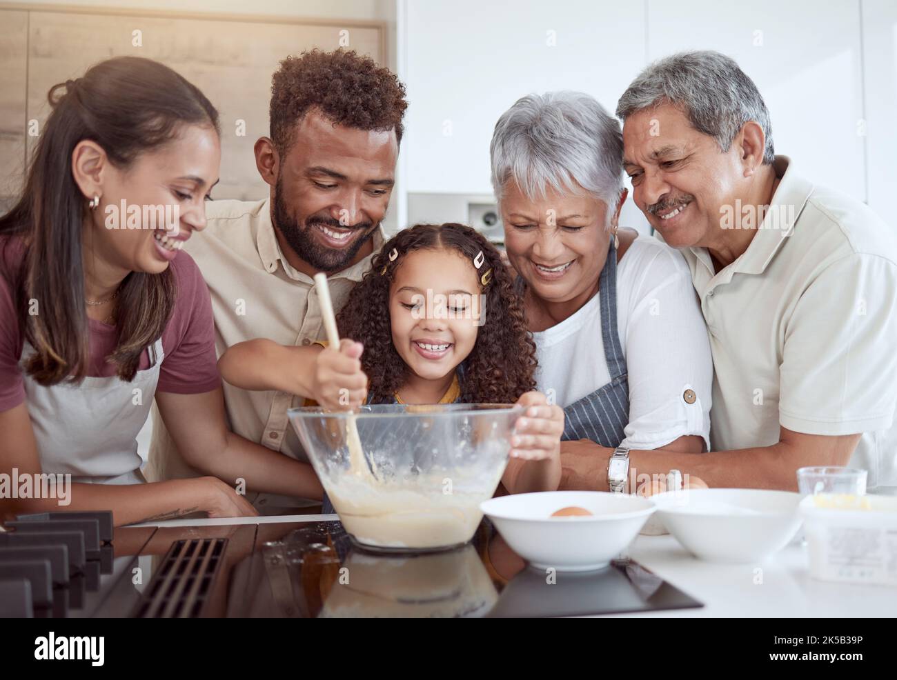 Baking, family and girl in kitchen for cake with ingredients and food ...