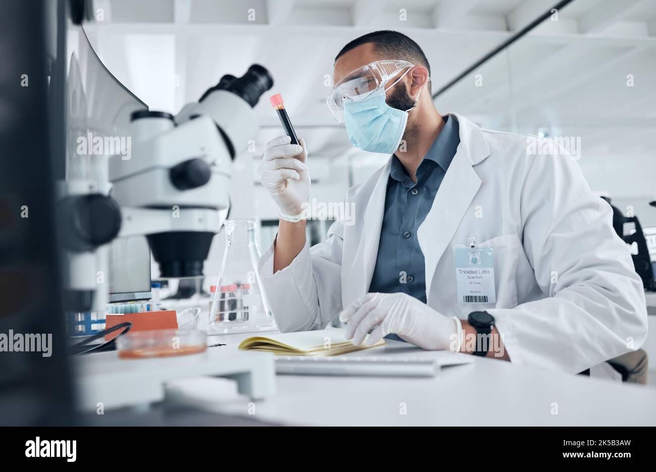 Science, blood and covid esearch with a man engineer working in a lab ...