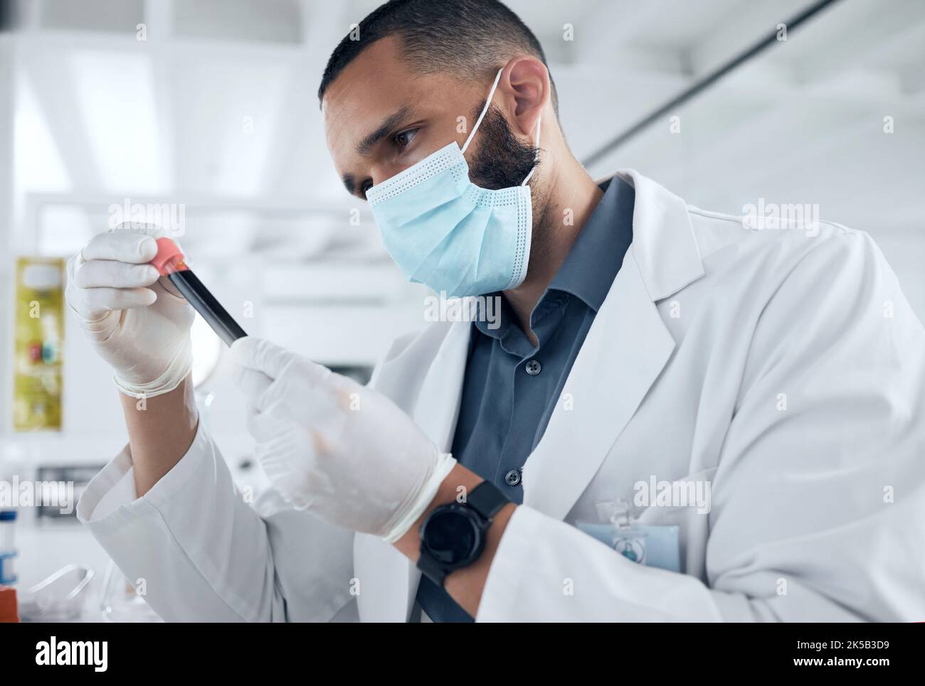 Covid, test tube and scientist in face mask doing research for medical ...