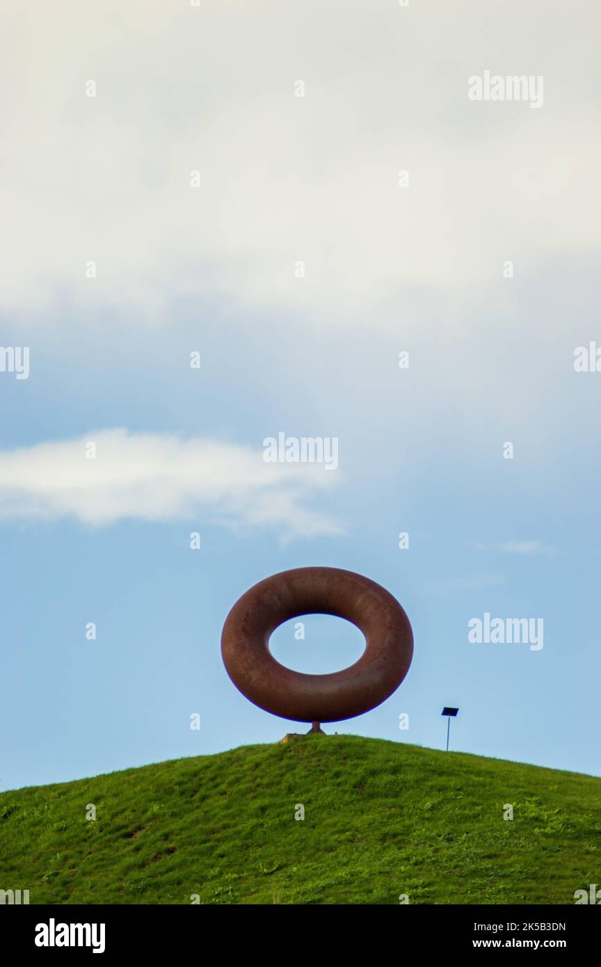 A round sculpture in greenery field Stock Photo - Alamy