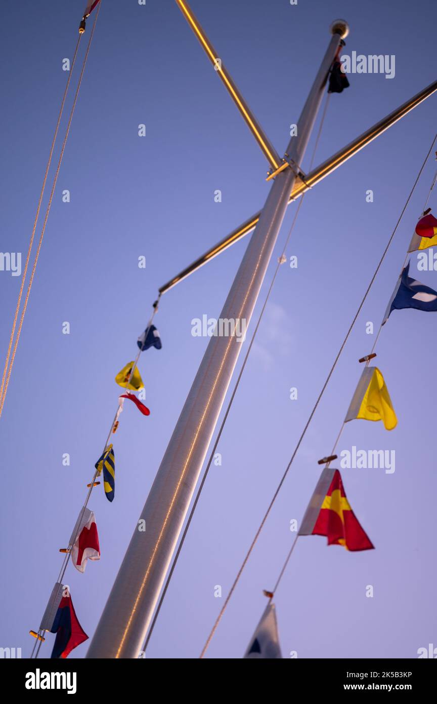 A low angle view of naval signal flags hanging from pole Stock Photo ...