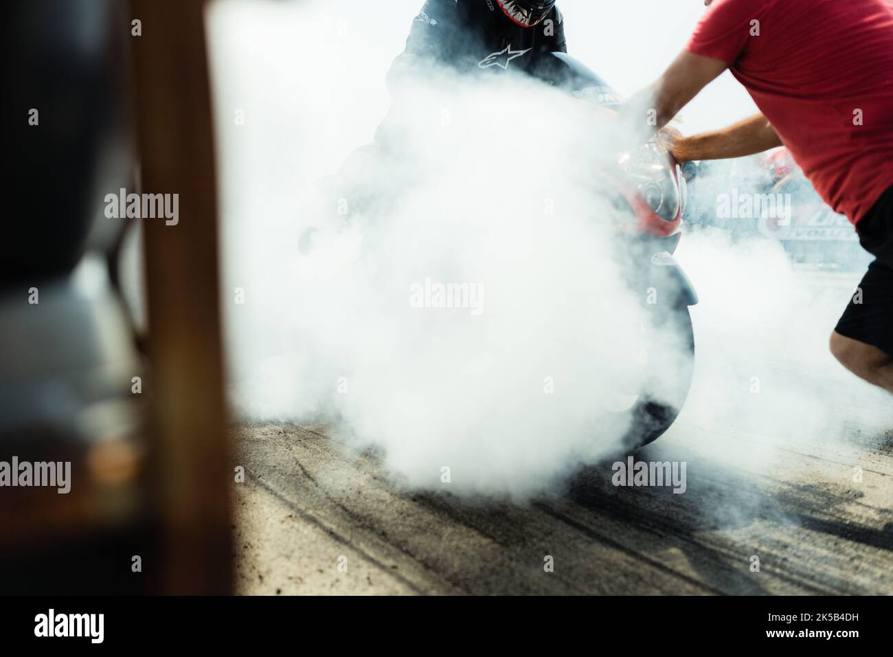 A male pushing a motorcycle during the Drag Racing event at the Arad ...