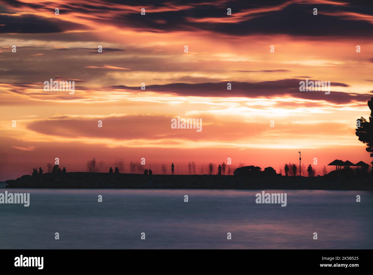 A long exposure shot of people shadows on golden sunset background near ...