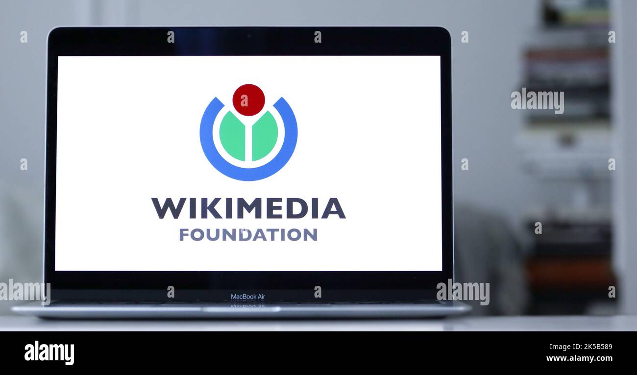 A laptop displaying the logo of the Wikimedia foundation a free online ...