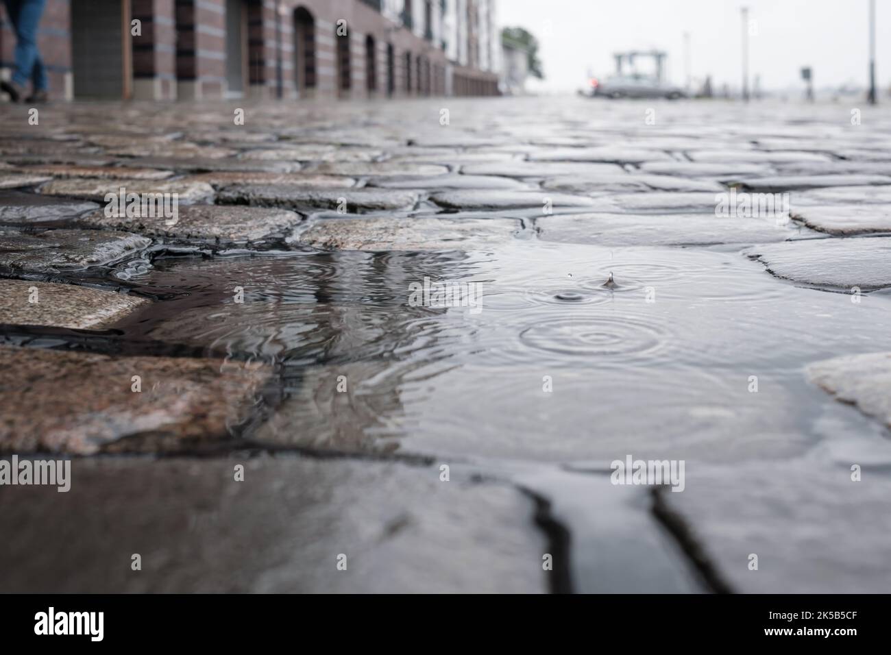 Raindrops in puddle on pavement hi-res stock photography and images - Alamy