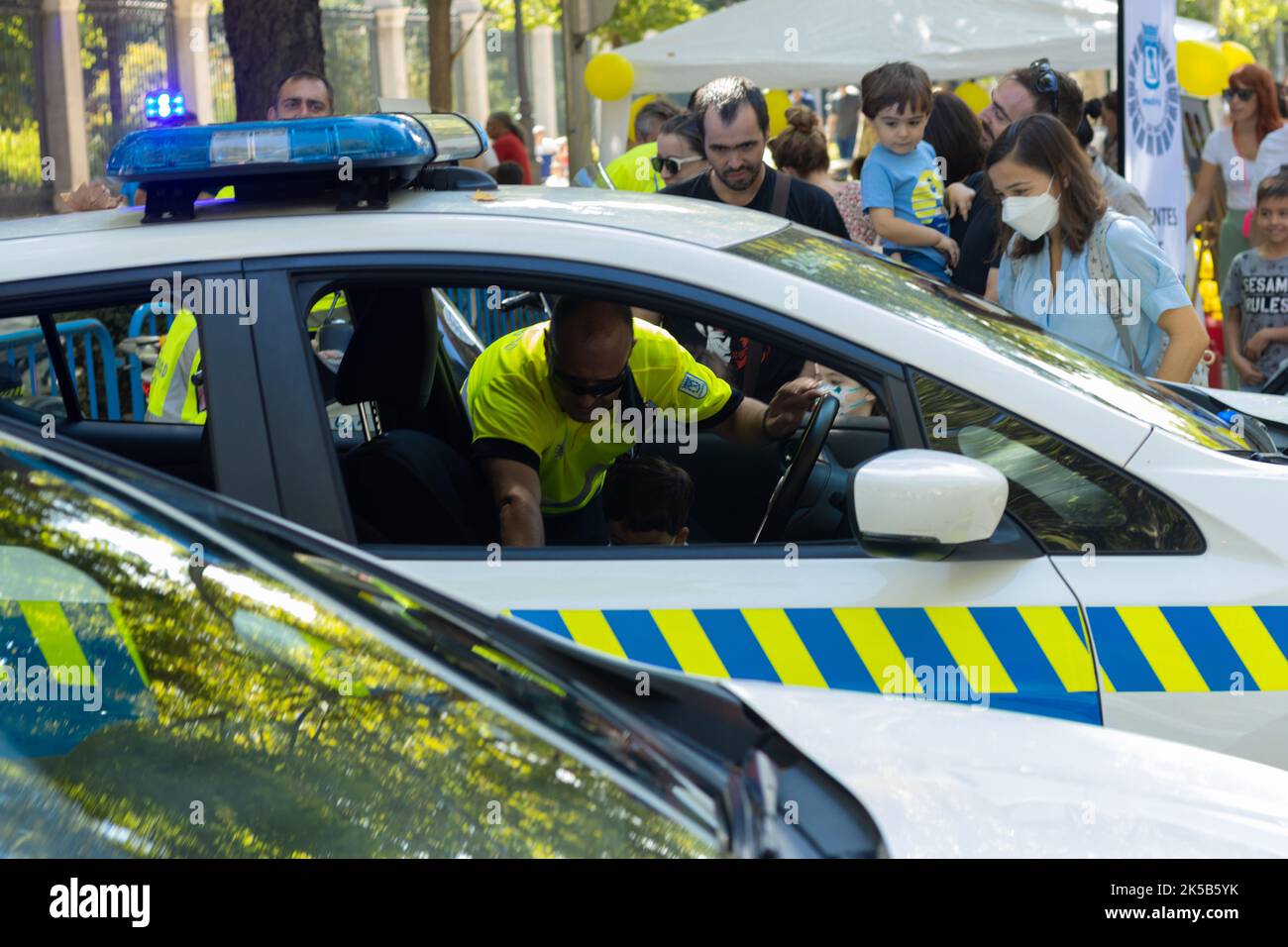 A police officer teaching children the basic traffic rules in a park ...