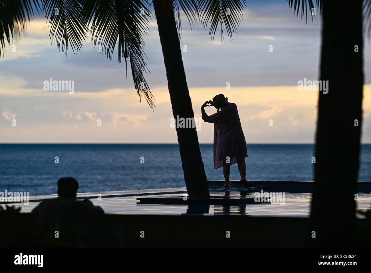 Sanya, China's Hainan Province. 3rd Oct, 2022. A tourist poses for a ...
