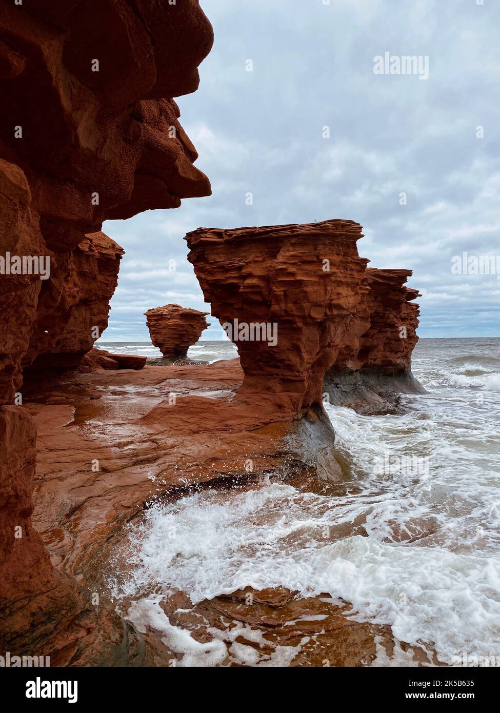 An aerial view of sea waves breaking rock formations in Prince Edward ...